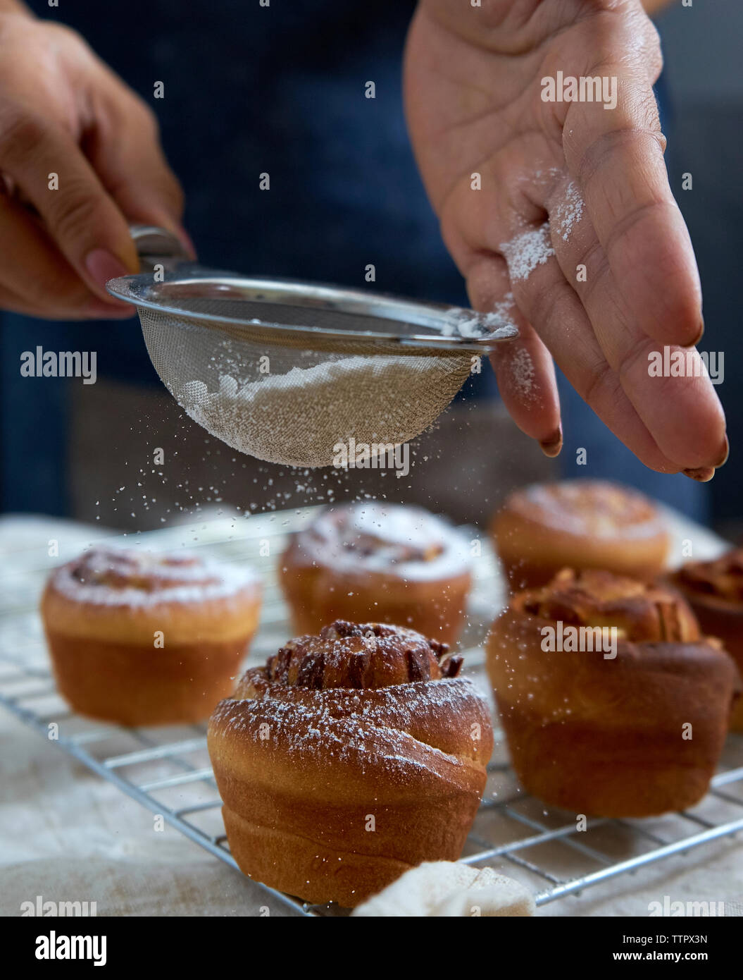 Woman sieving sugar on hi-res stock photography and images - Alamy