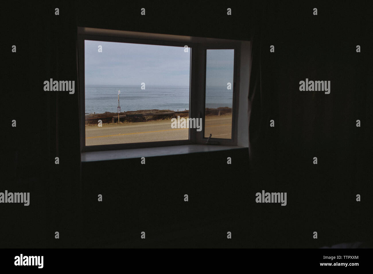 Scenic view of sea seen through window Stock Photo - Alamy