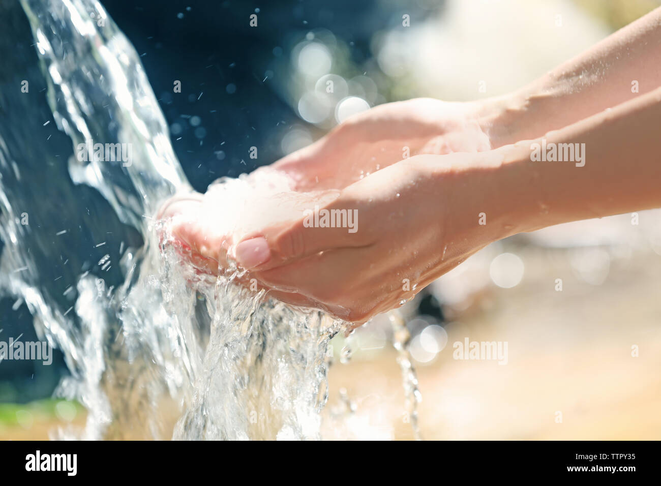 Water dropping from woman's hands Stock Photo - Alamy
