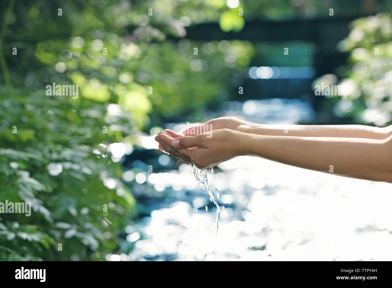 Water dropping from woman's hands Stock Photo - Alamy