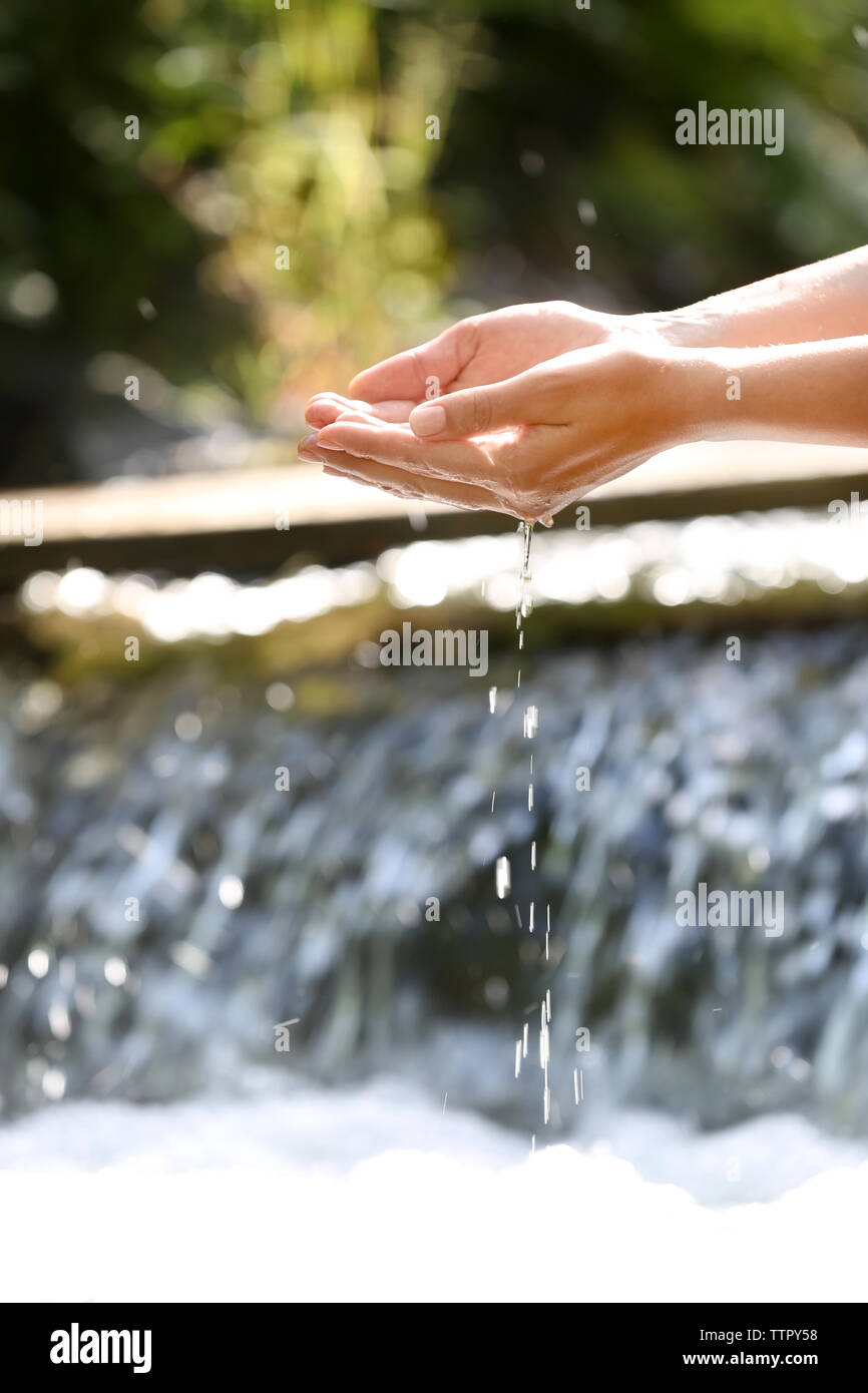 Water dropping from woman's hands Stock Photo - Alamy