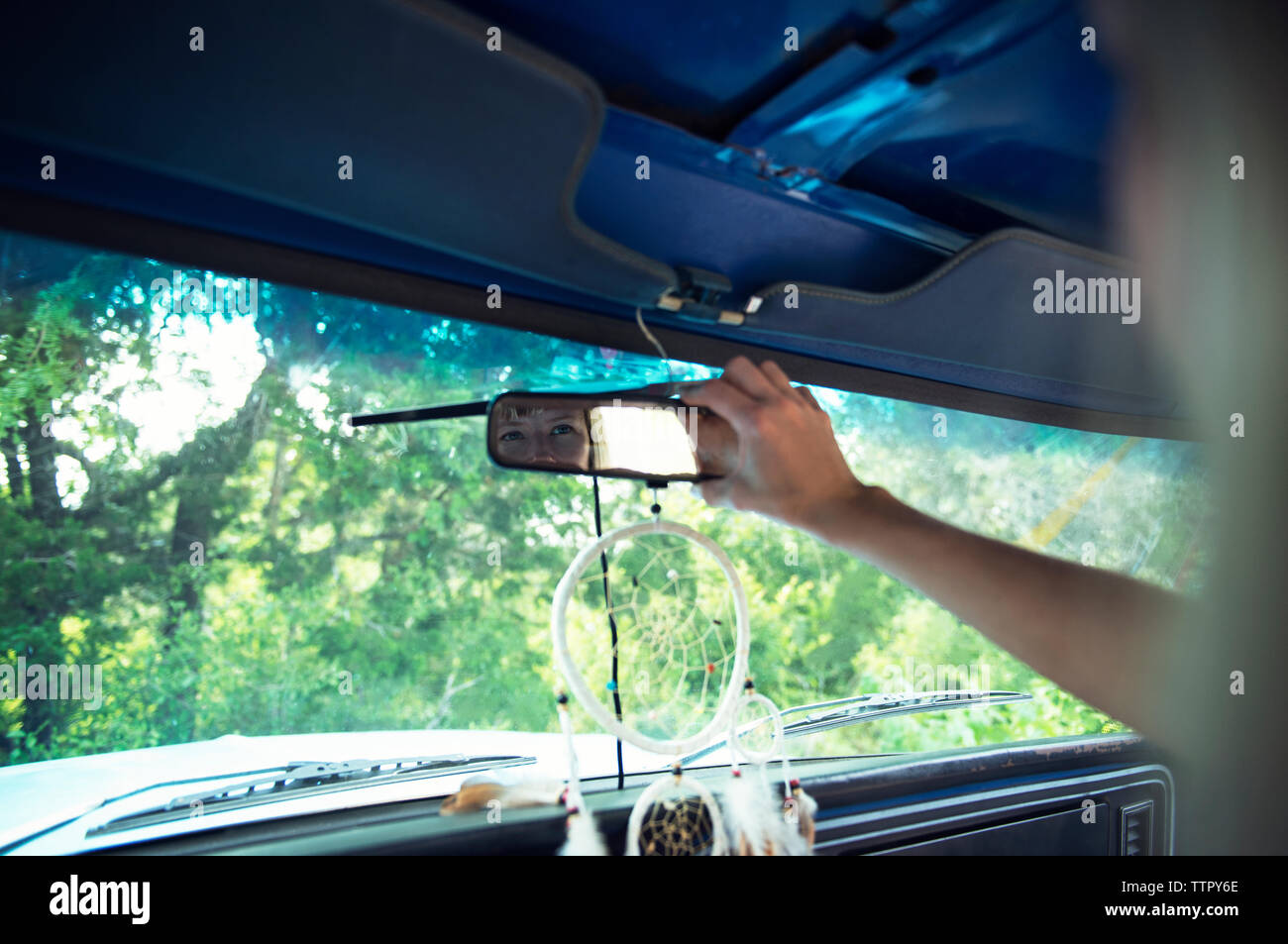 Woman adjusting rear-view mirror while sitting in pick-up truck Stock ...