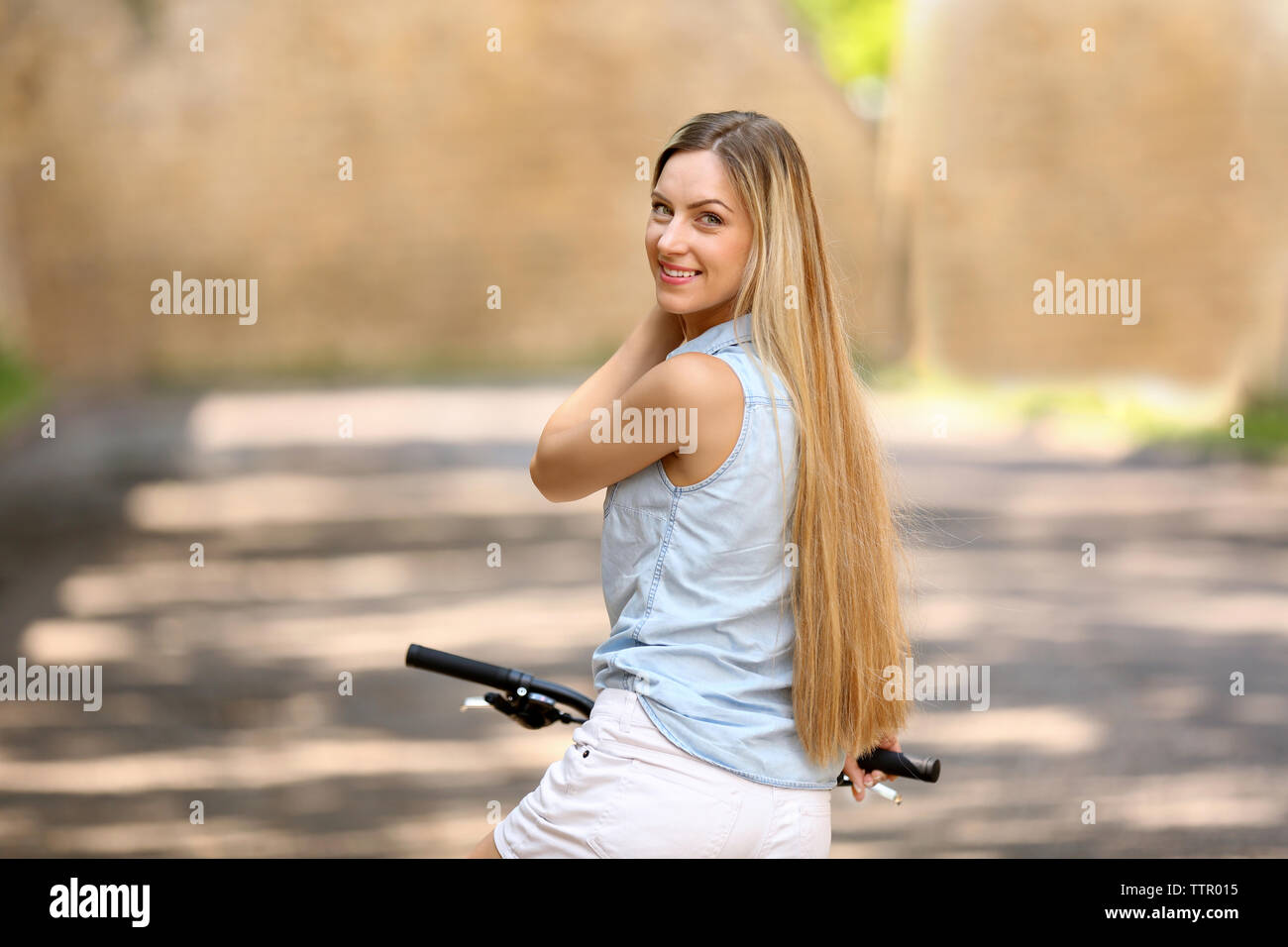 Beautiful girl riding bike on street Stock Photo - Alamy