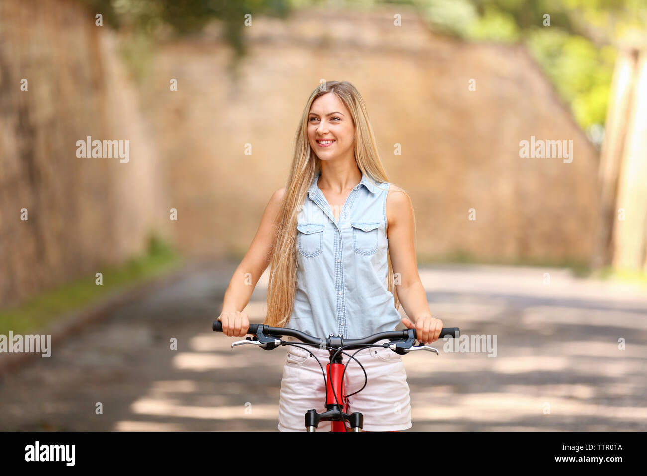 Beautiful girl riding bike on street Stock Photo - Alamy