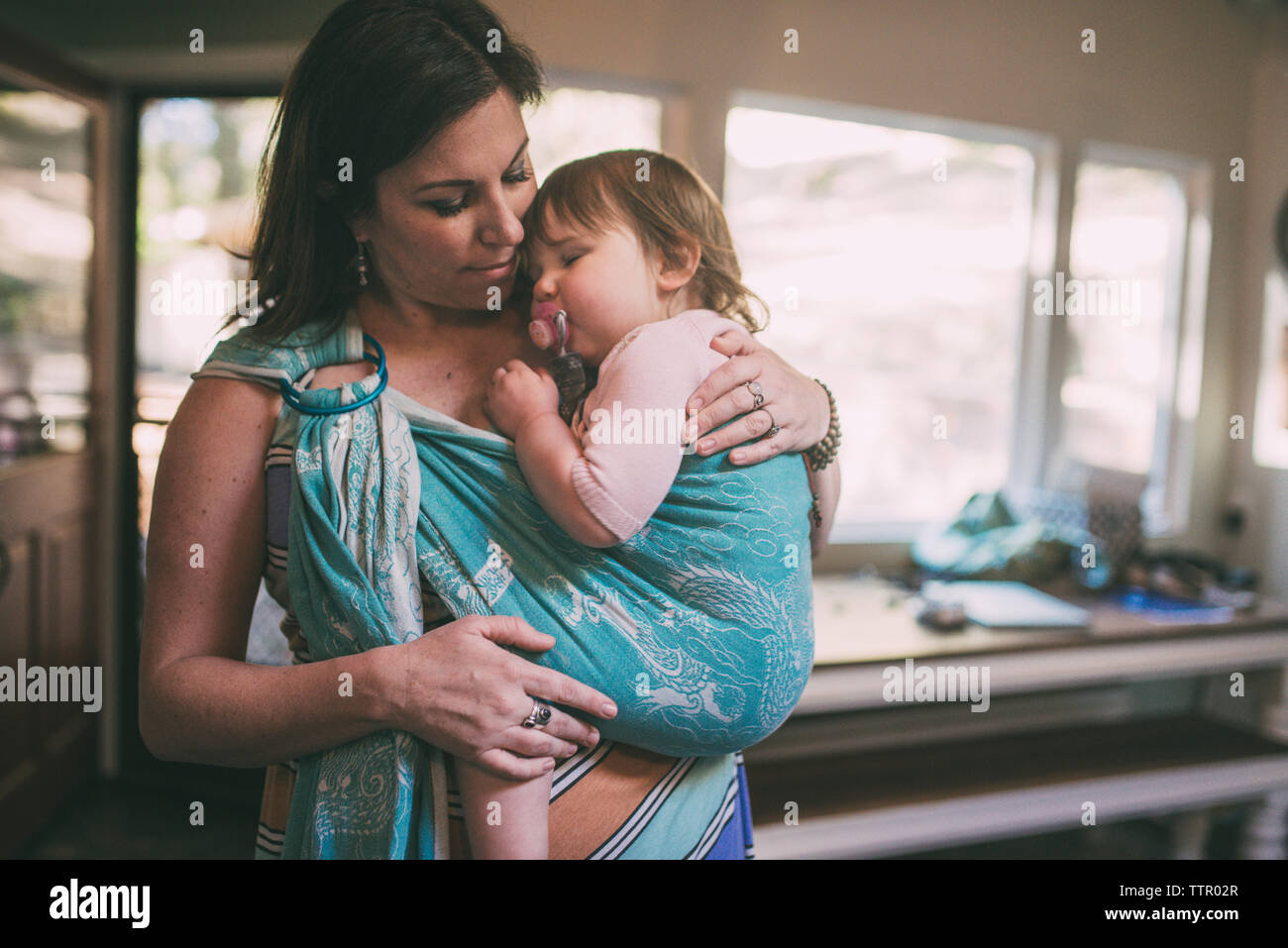 Mother carrying girl at home Stock Photo - Alamy