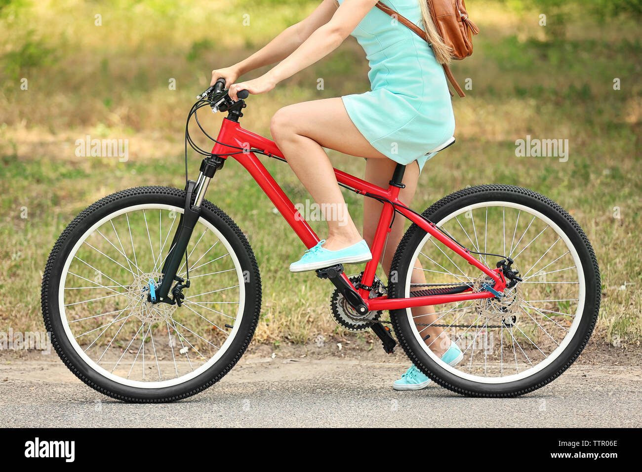 Girl riding bicycle on street Stock Photo - Alamy
