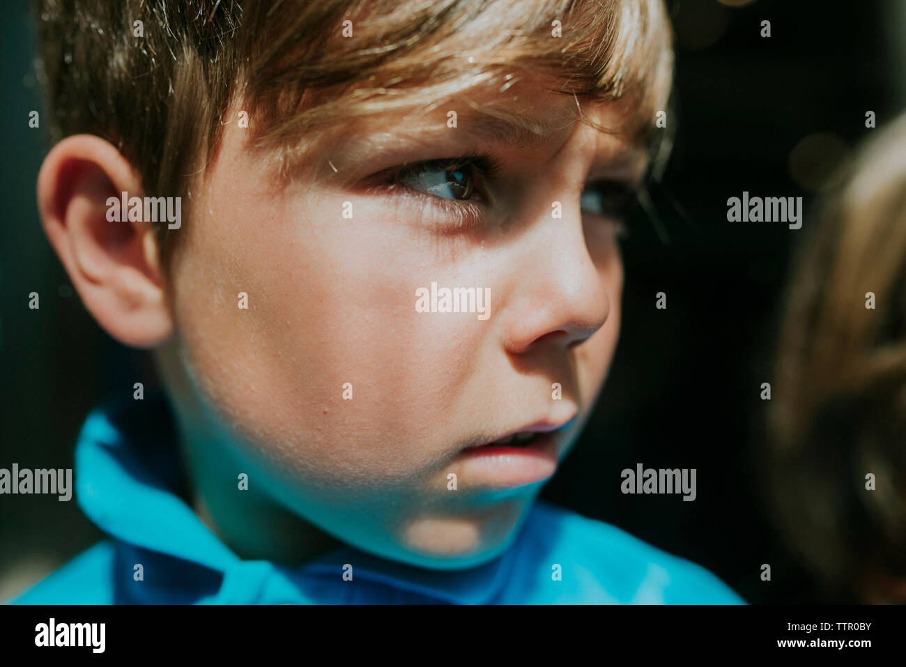 Close-up of thoughtful boy looking away Stock Photo - Alamy