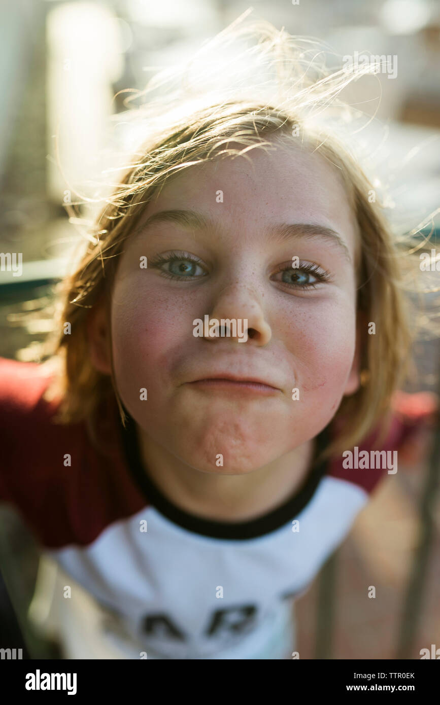 High angle portrait of girl making face while standing outdoors Stock ...