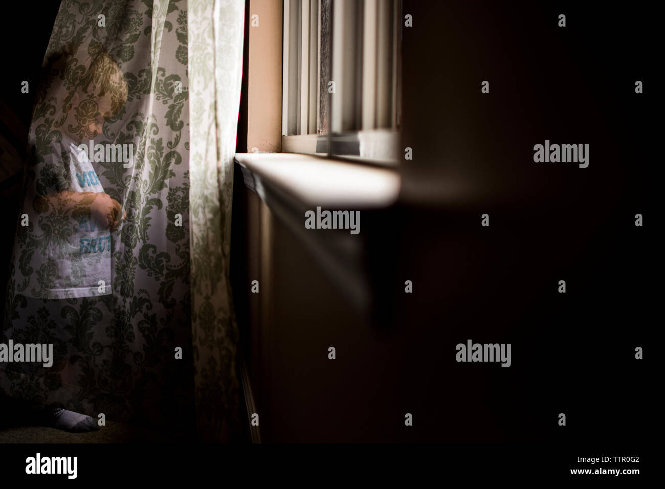 Boy hiding behind hi-res stock photography and images - Alamy