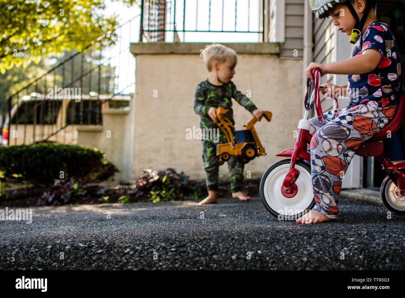 Brothers playing in backyard Stock Photo - Alamy
