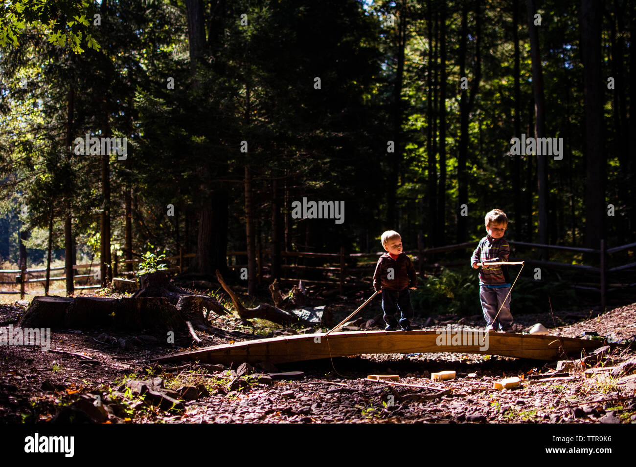 Brothers playing with toys in playground Stock Photo - Alamy