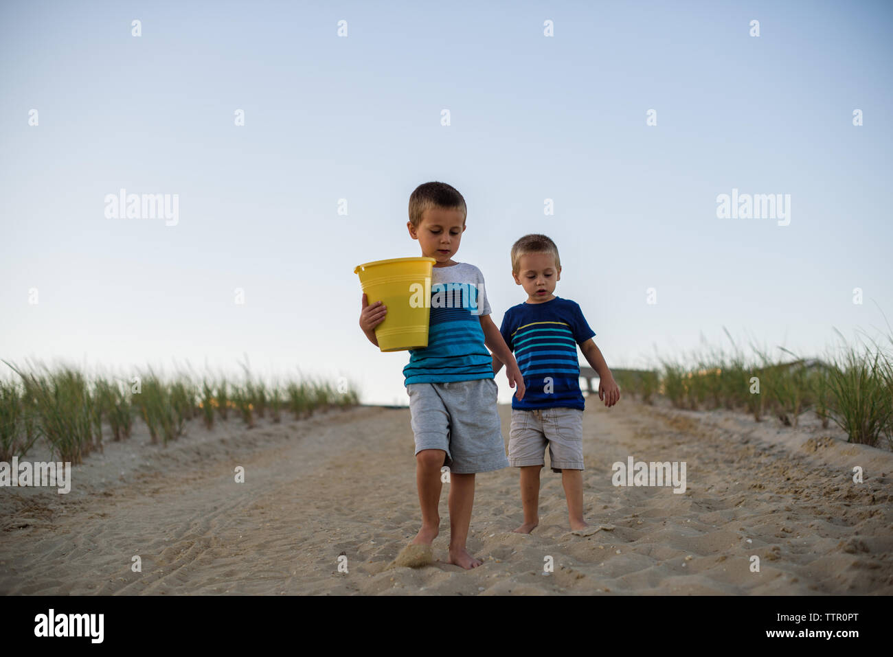 Two Boys Carrying Bucket High Resolution Stock Photography and Images ...