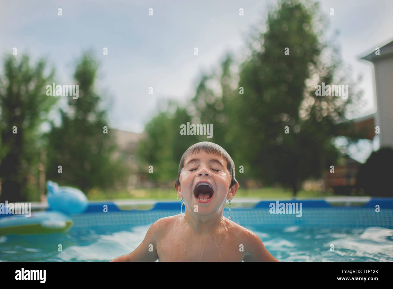 Boy swimming in wading pool Stock Photo - Alamy
