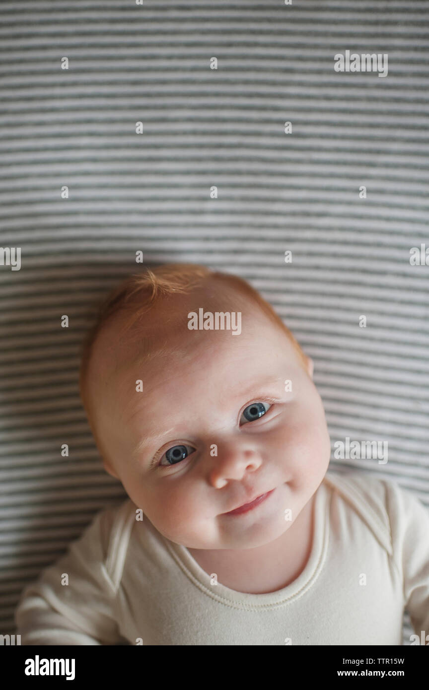 Overhead portrait of baby boy lying on bed Stock Photo - Alamy