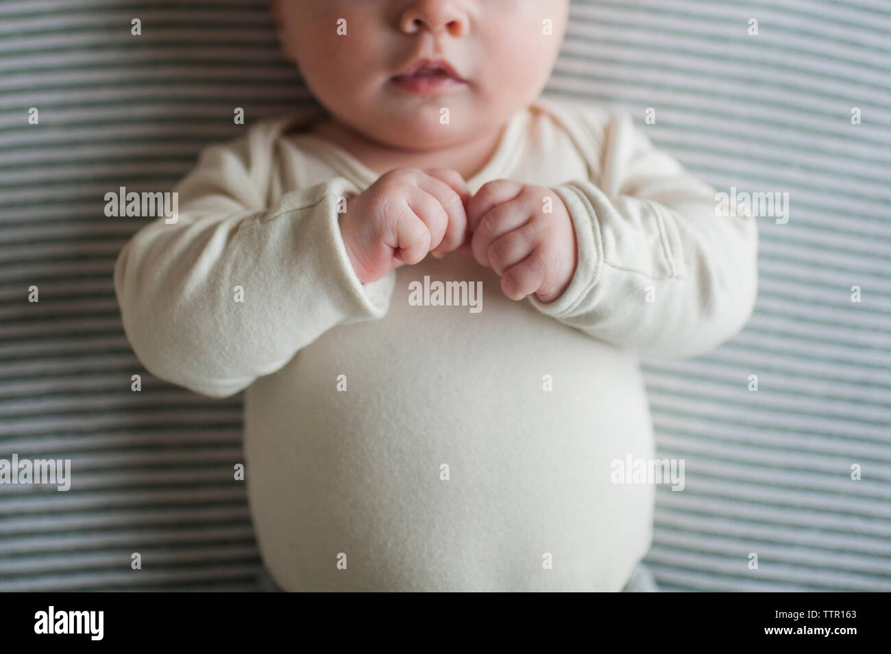 Midsection of baby boy lying on bed Stock Photo - Alamy