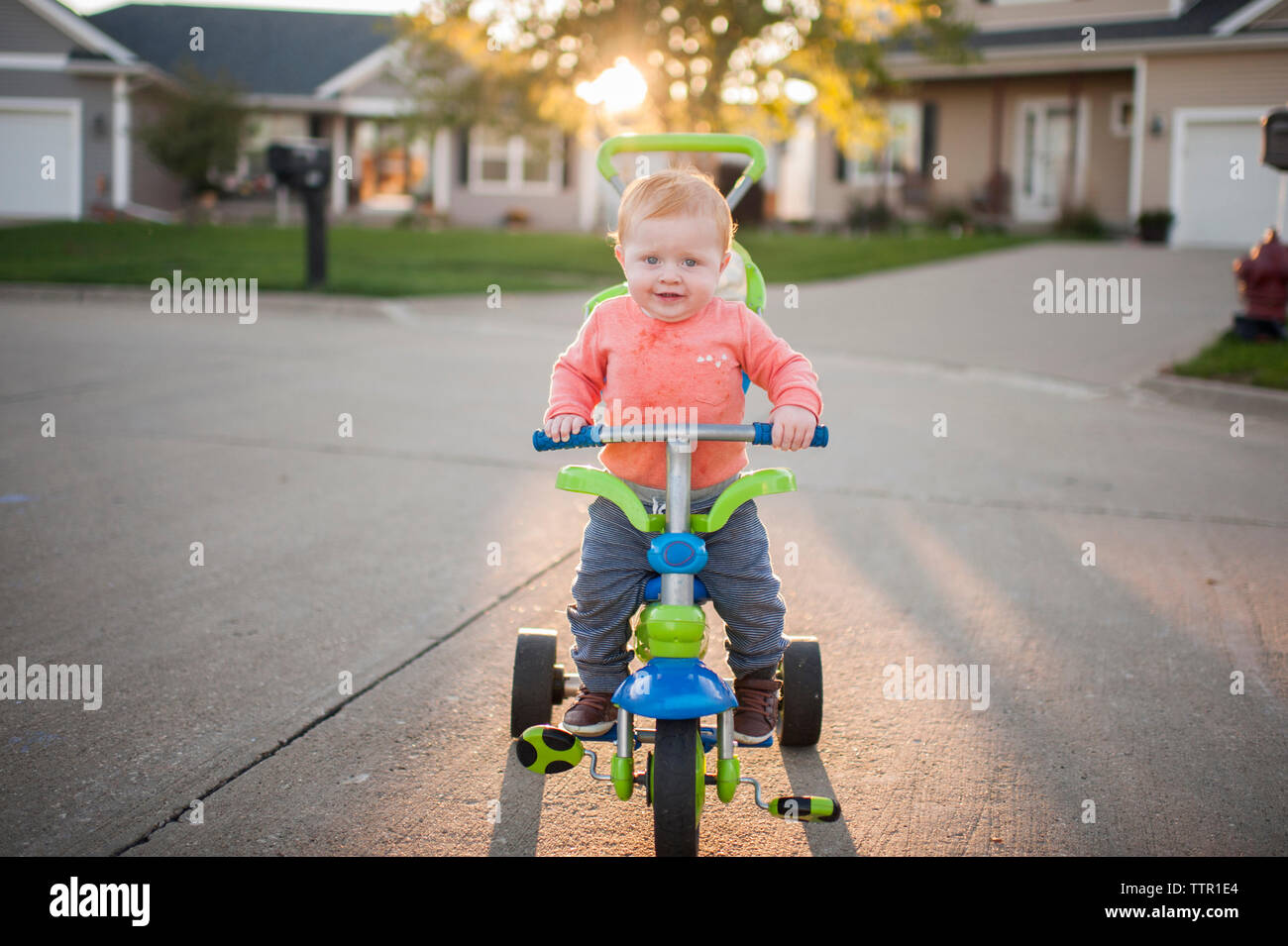 Baby riding tricycle hi-res stock photography and images - Alamy