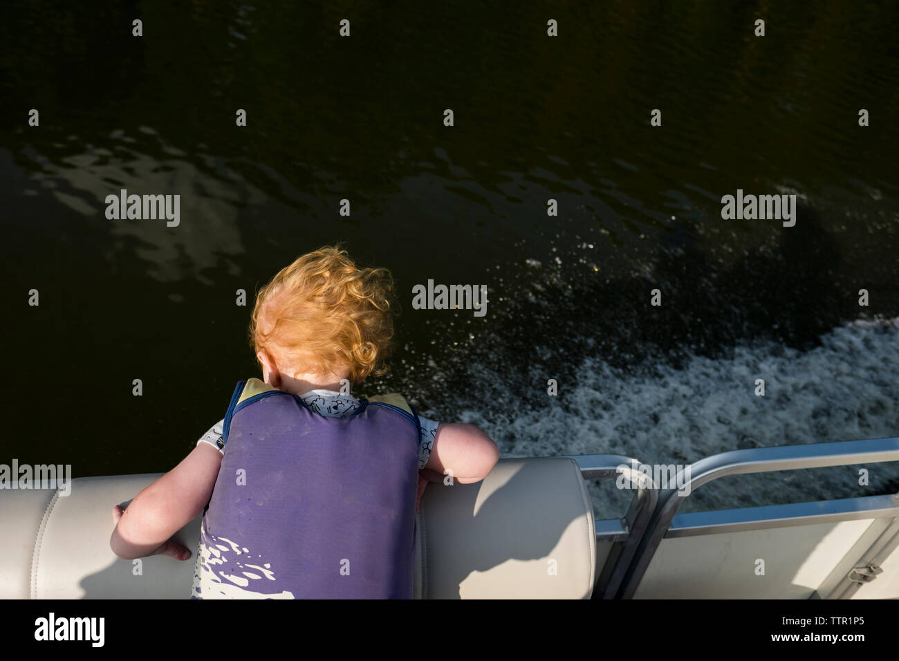 Boy leaning railing outdoors hi-res stock photography and images - Alamy