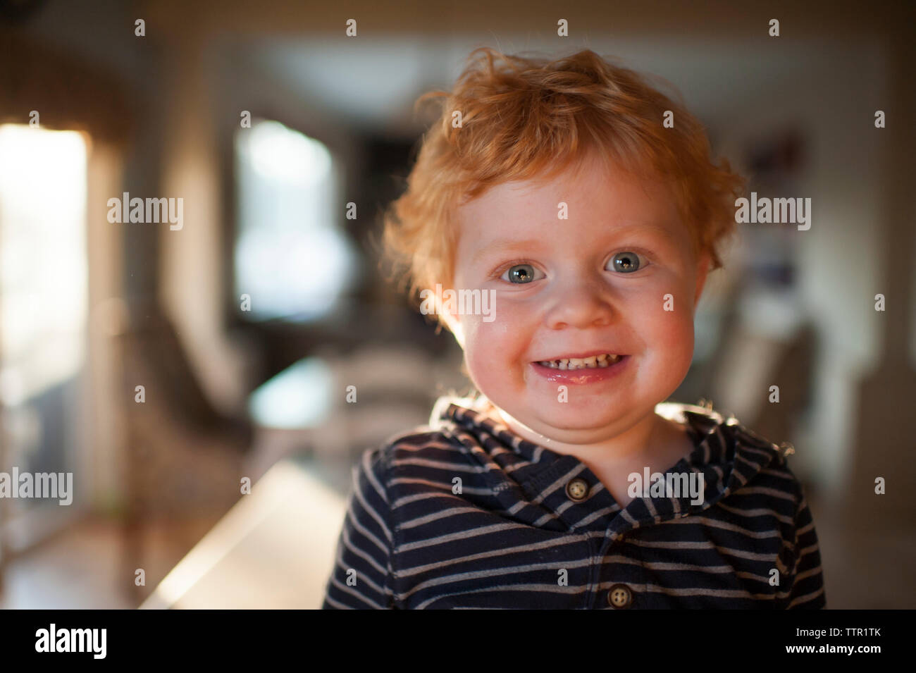 Portrait of young boy giving cute cheesy smile at home Stock Photo - Alamy