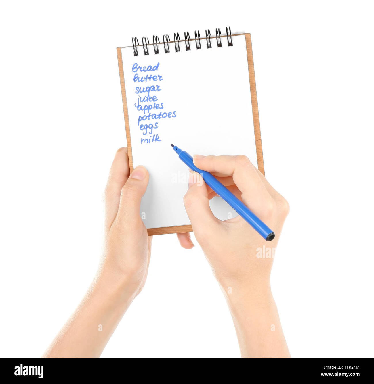 Hands holding pen and notepad with shopping list on white background ...
