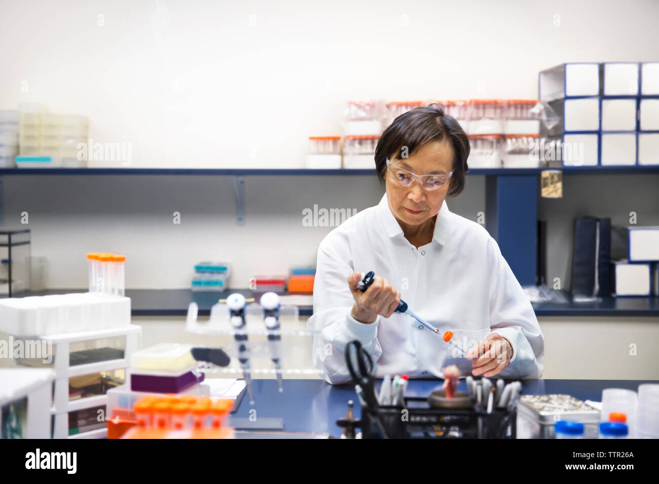 Woman using pipette in hi-res stock photography and images - Alamy