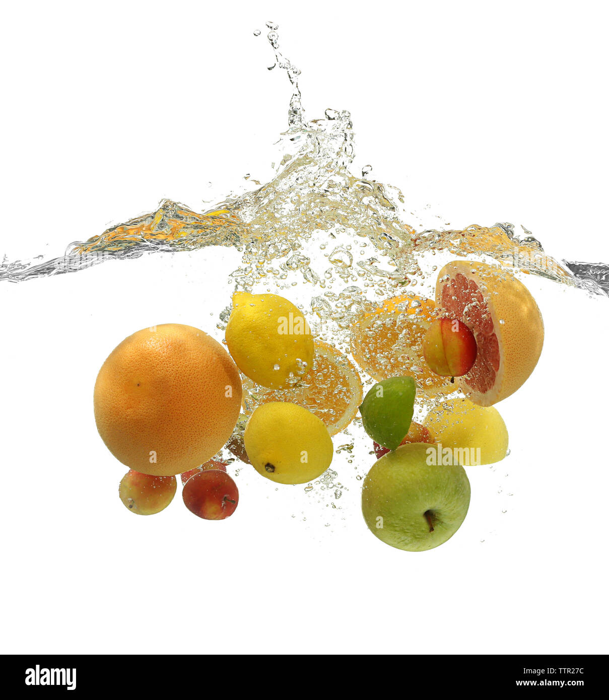 Fruits falling into water on white background Stock Photo - Alamy