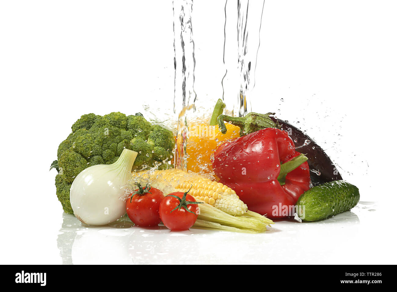 Vegetables with splashing water on white background Stock Photo - Alamy