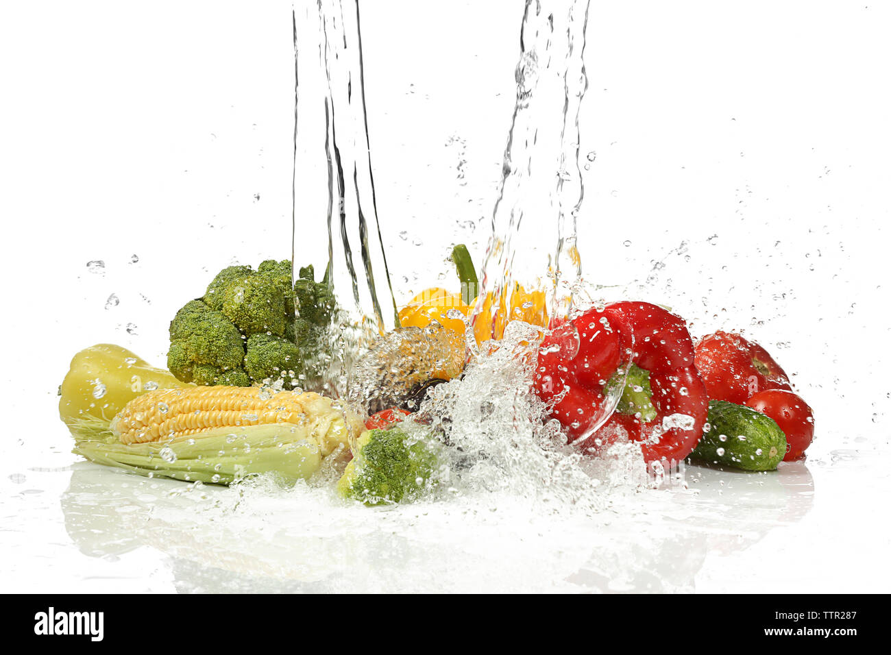 Vegetables with splashing water on white background Stock Photo - Alamy