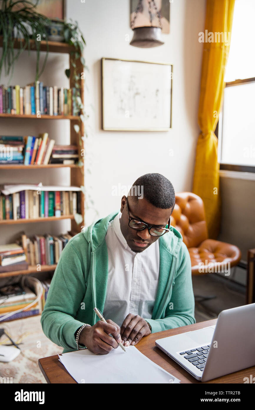 African man writing on paper hi-res stock photography and images - Alamy