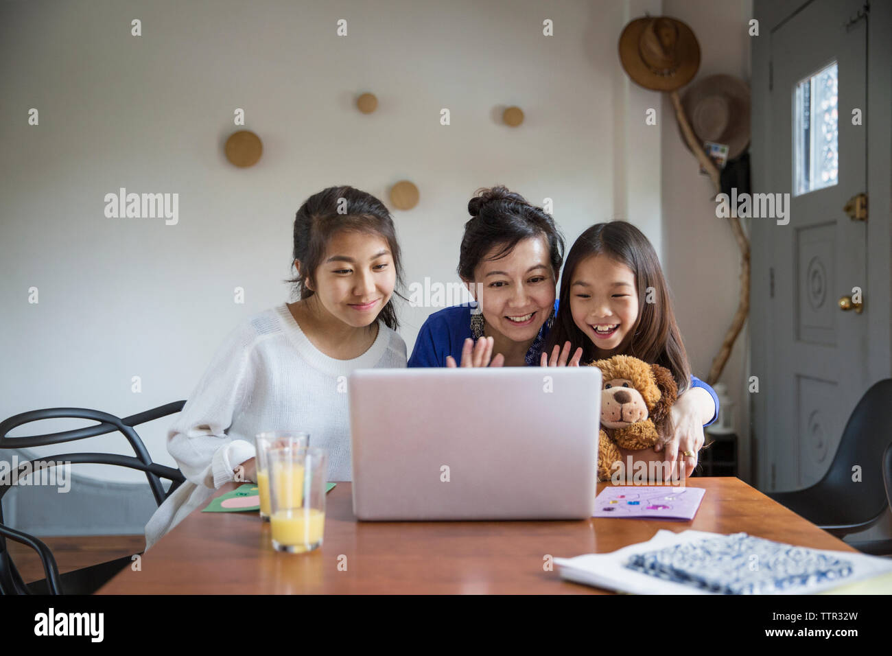 Happy family doing video call with laptop at home Stock Photo - Alamy