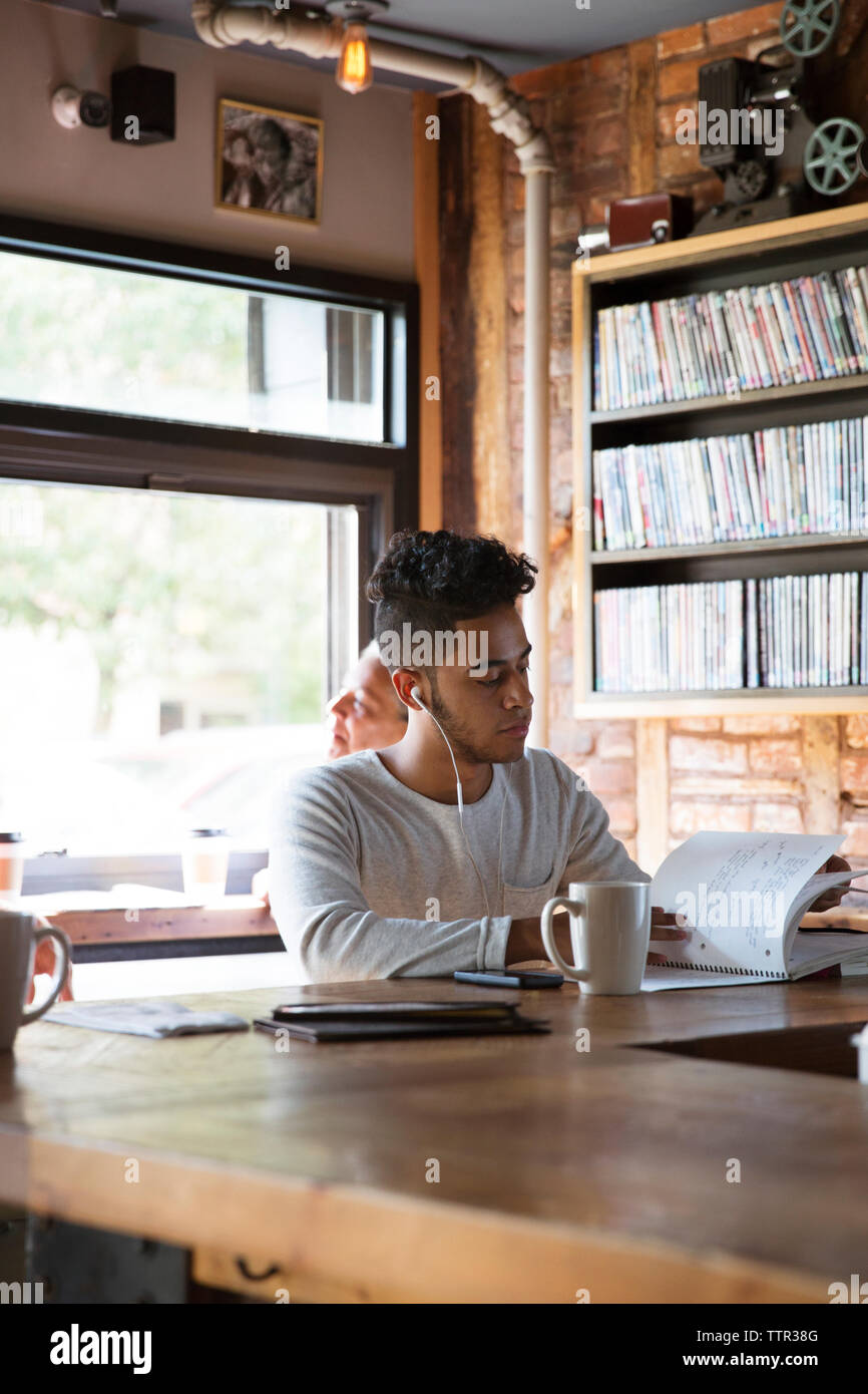 Woman in coffee shop listening music hi-res stock photography and ...