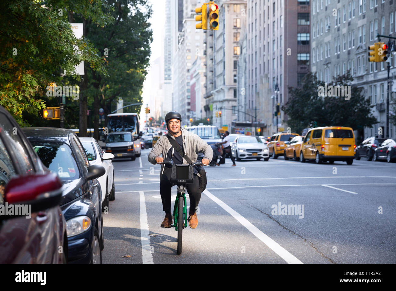 Happy man riding bicycle on city street Stock Photo - Alamy
