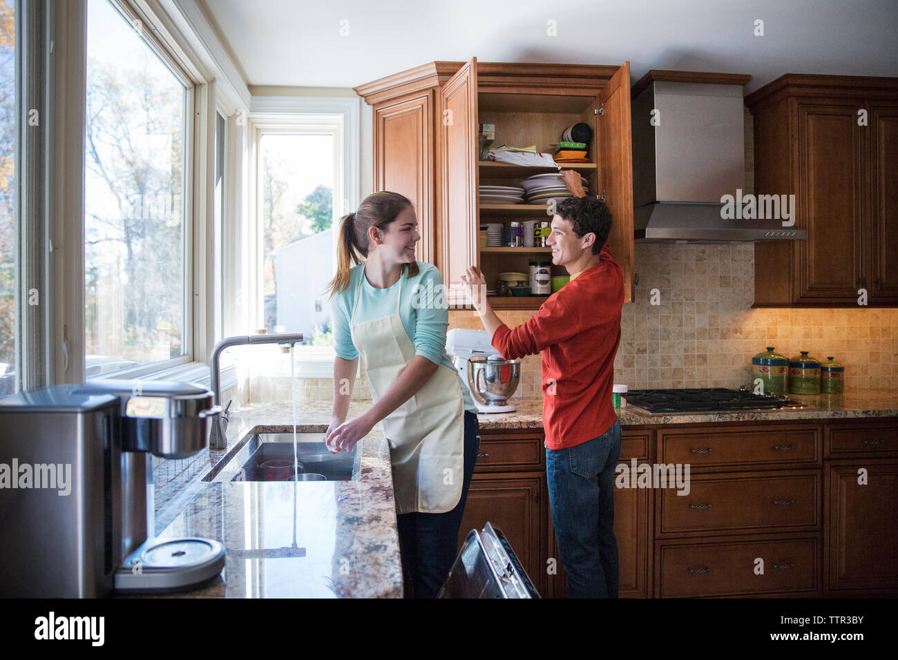 Working in kitchen hi-res stock photography and images - Alamy