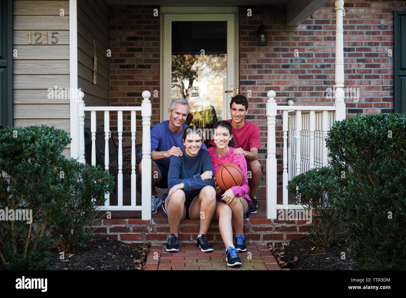 Young woman sitting on stoop hi-res stock photography and images - Alamy