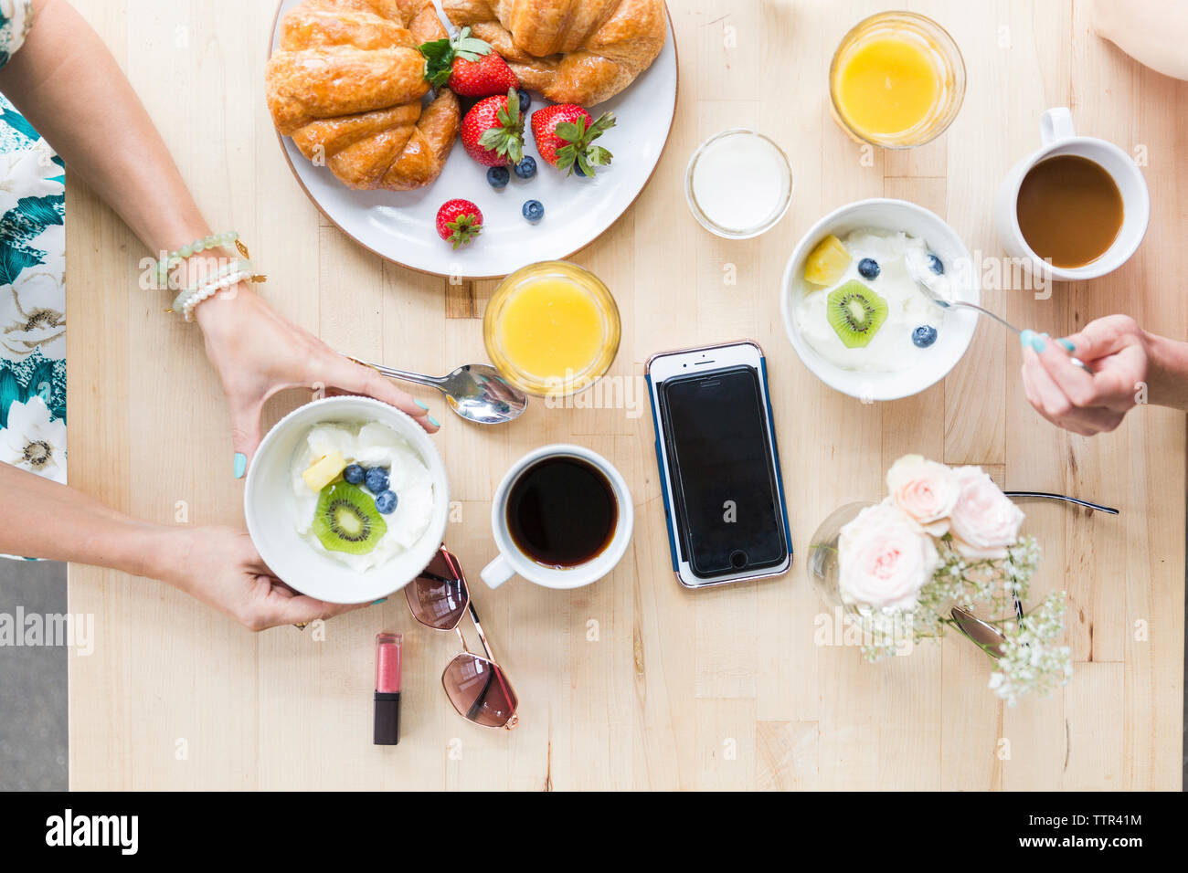 Overhead view of friends having breakfast at table in cafe Stock Photo ...