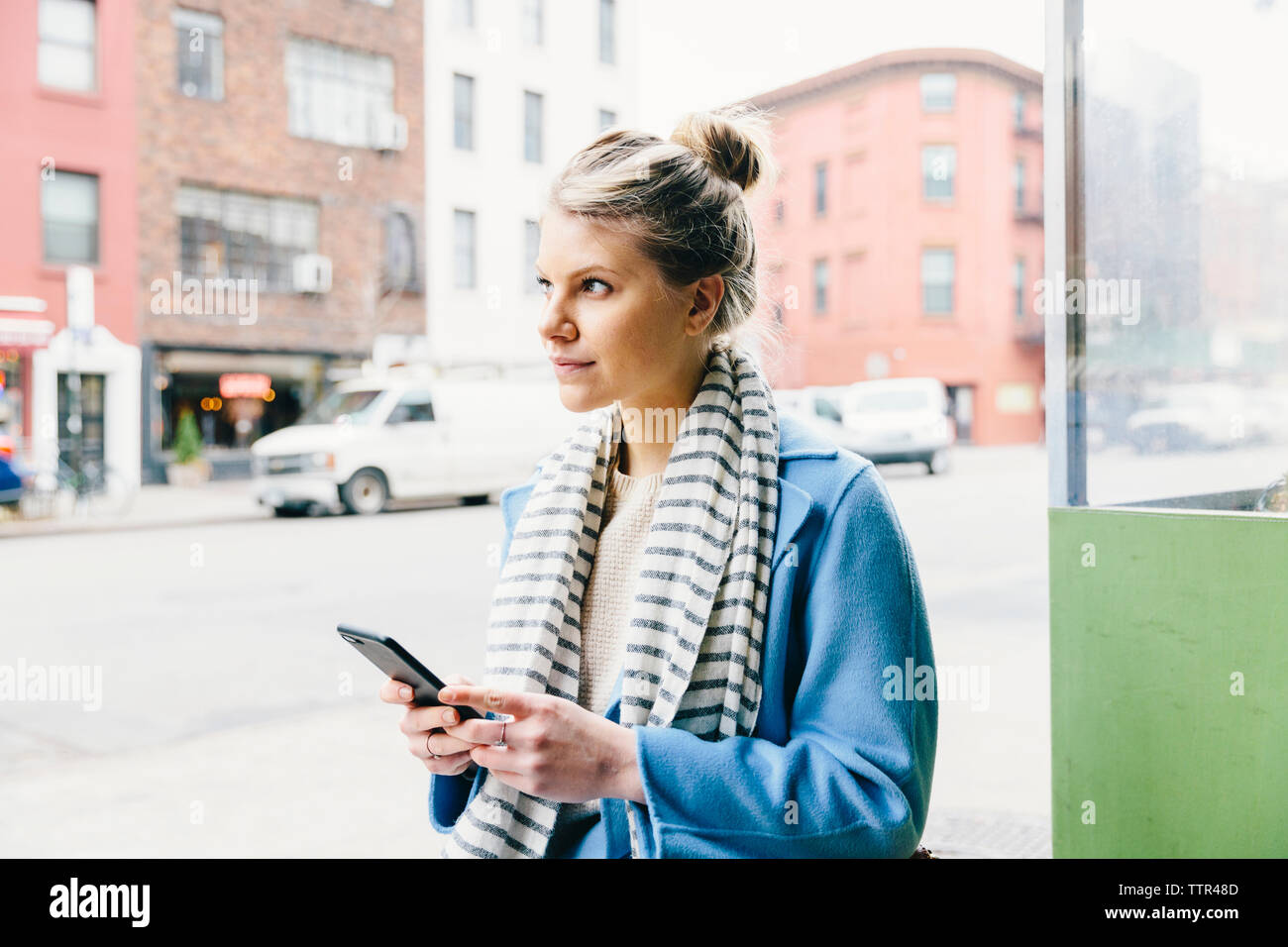 Woman in blue coat using hi-res stock photography and images - Alamy