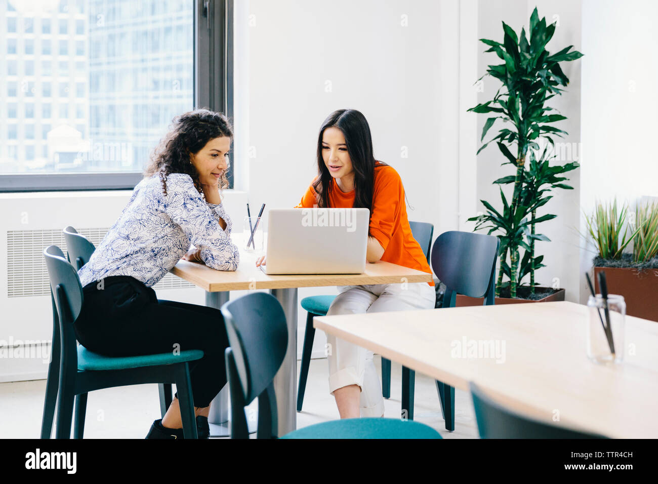 Coworkers discussing business plan in hi-res stock photography and images - Alamy