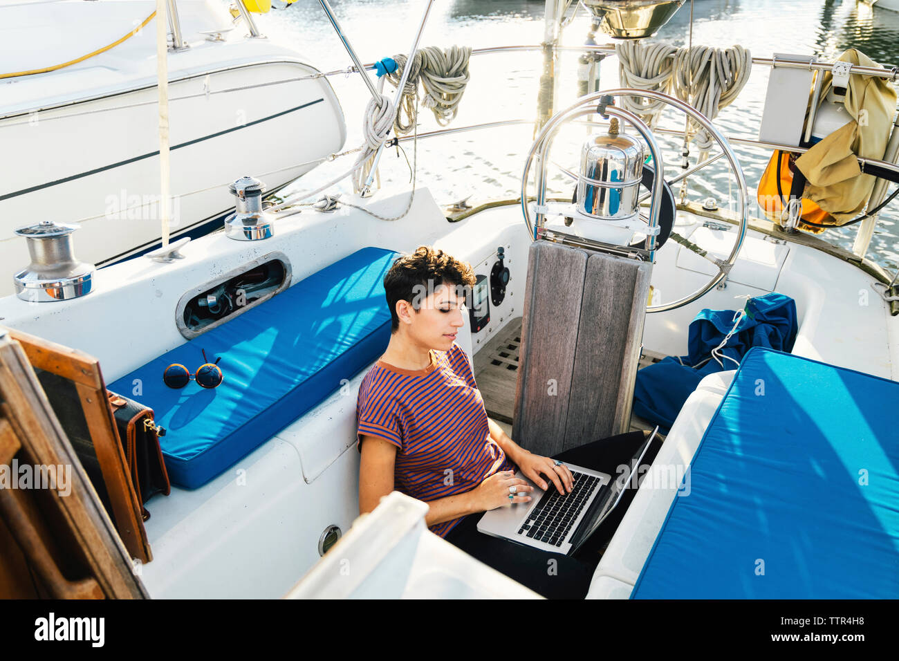 Woman steering boat hi-res stock photography and images - Alamy