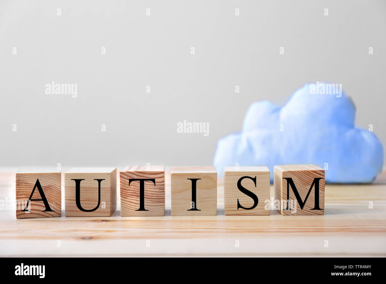 Word autism made of wooden cubes on wall background Stock Photo - Alamy