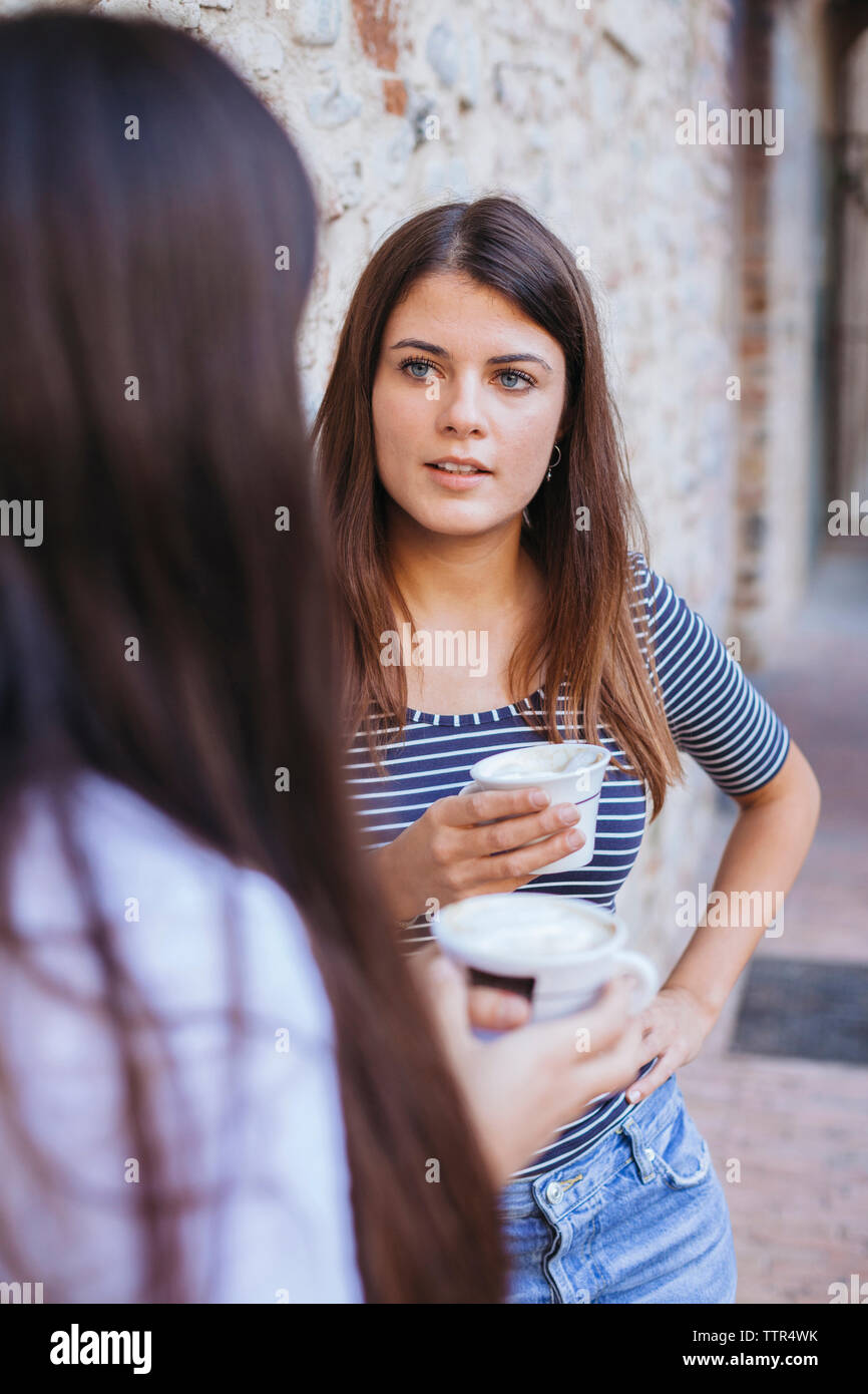Friends talking women cups hi-res stock photography and images - Alamy