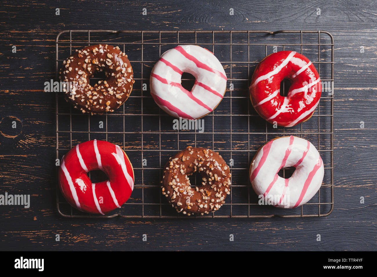 Overhead view of colorful donuts on cooling rack Stock Photo - Alamy