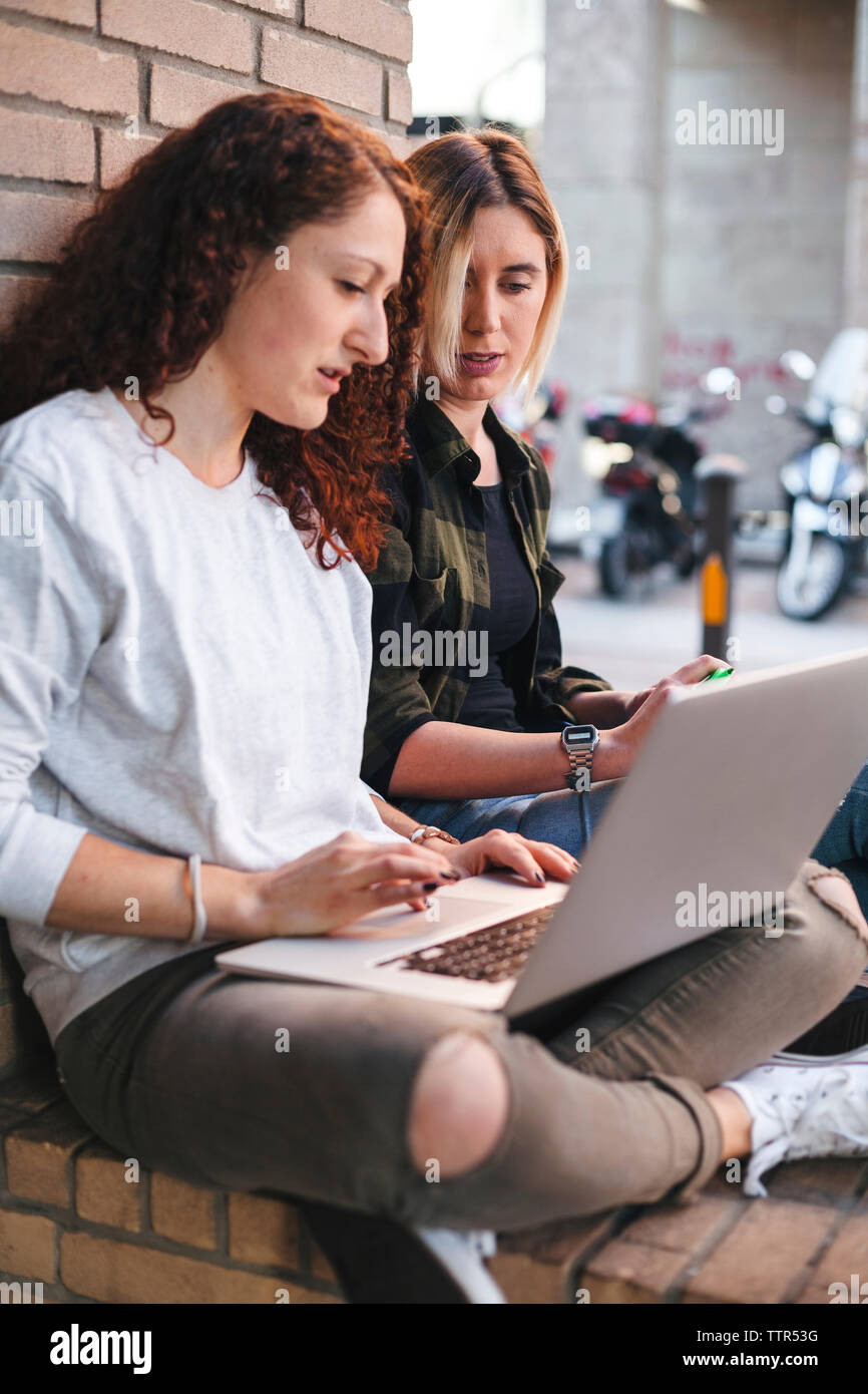 Two young students at the University using laptop Stock Photo - Alamy