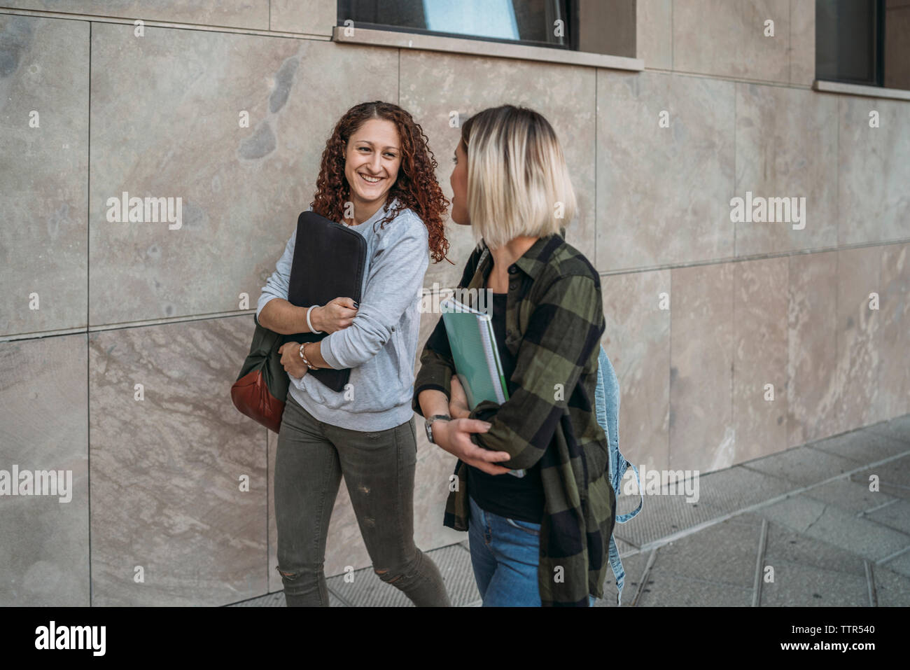 Two young students walking together in the college Stock Photo - Alamy