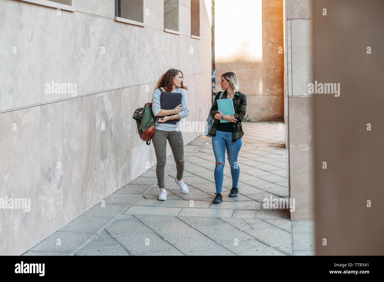 Young adult students walking college campus hi-res stock photography ...