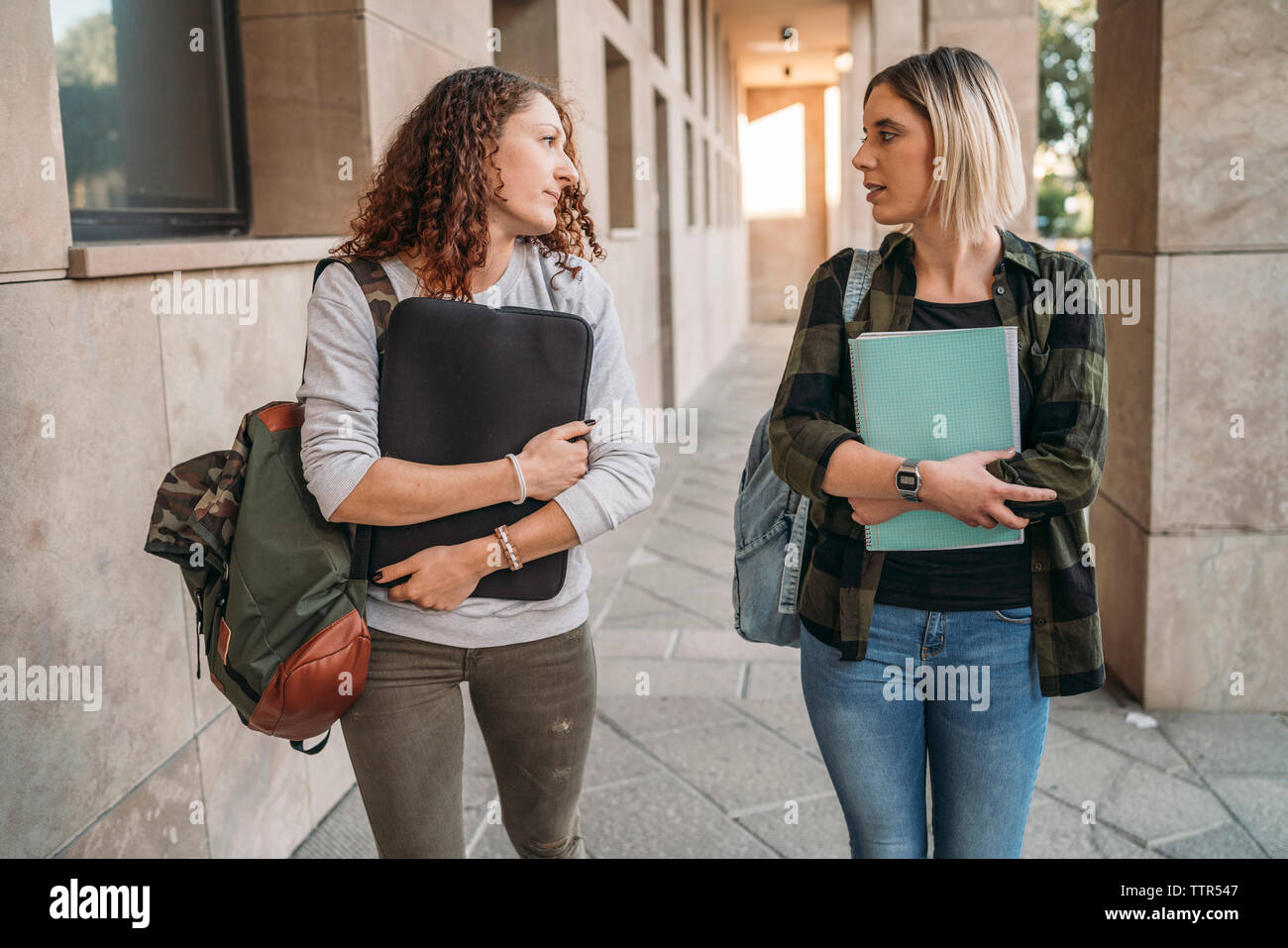 Two young students walking together in the college Stock Photo - Alamy