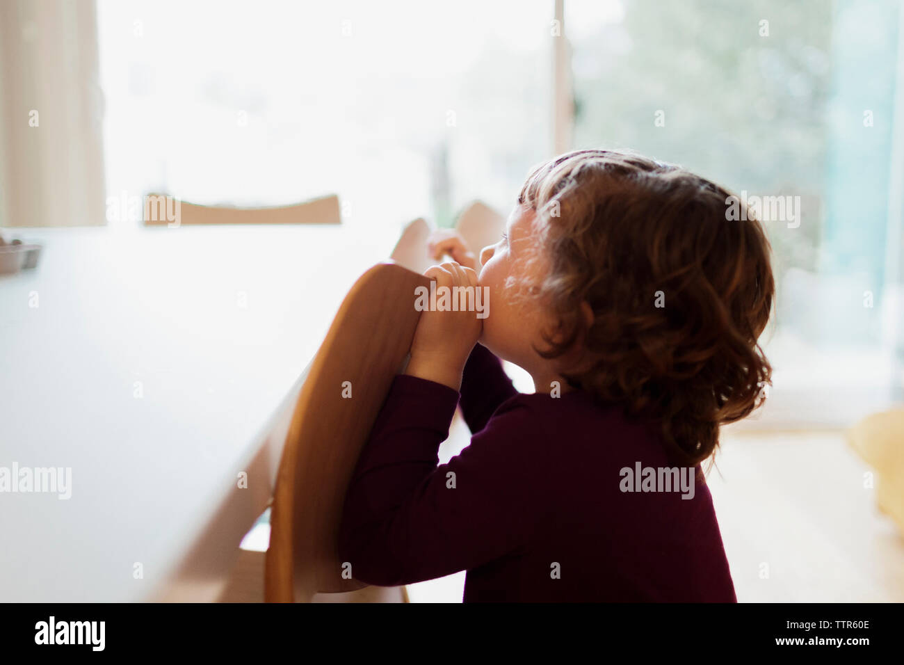 Girl Hiding Behind Chair Stock Photos & Girl Hiding Behind Chair Stock ...