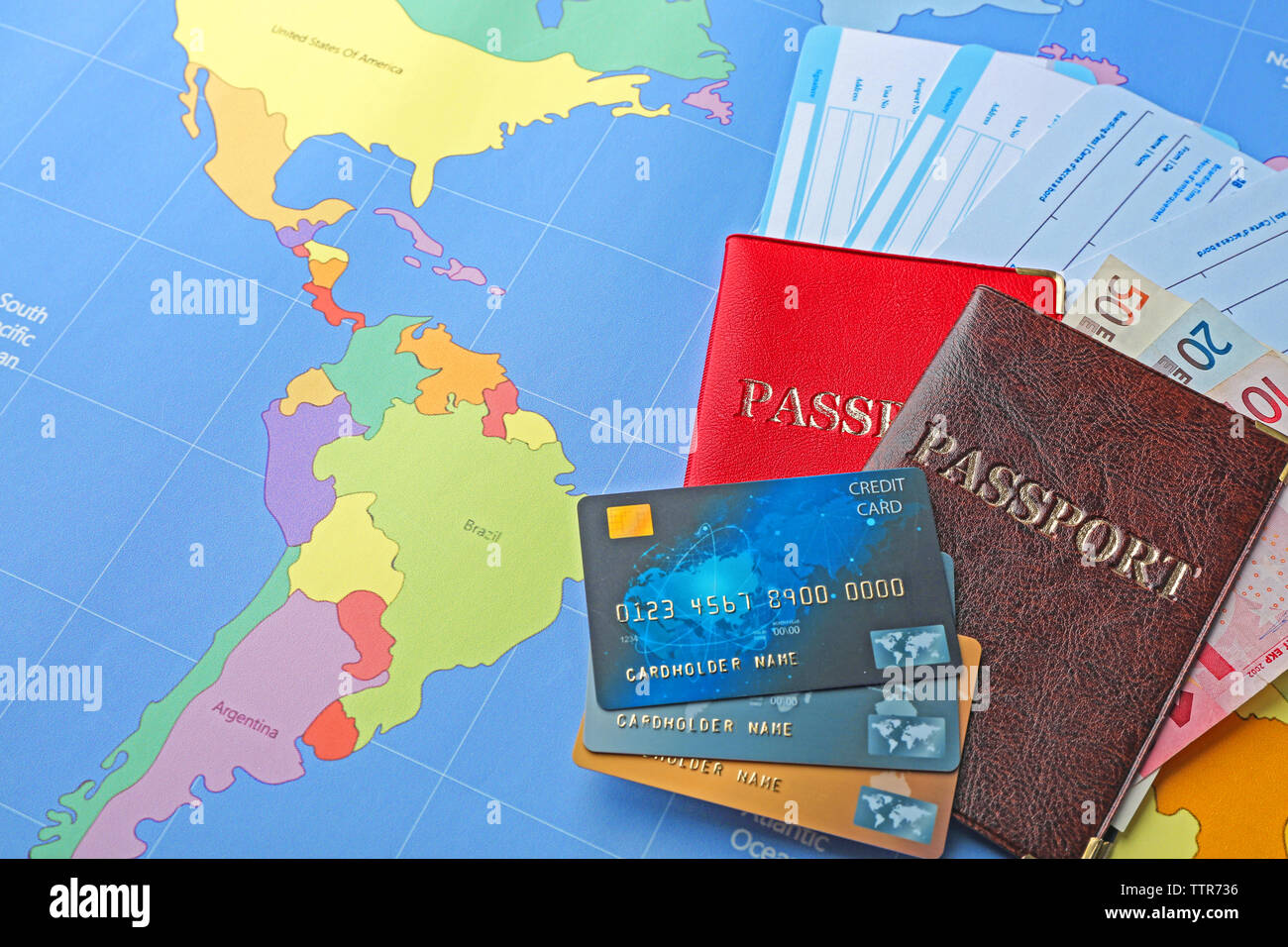 Credit cards and tickets on world map background Stock Photo - Alamy