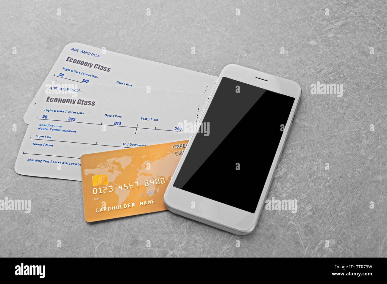 Credit card and air tickets on grey background Stock Photo - Alamy