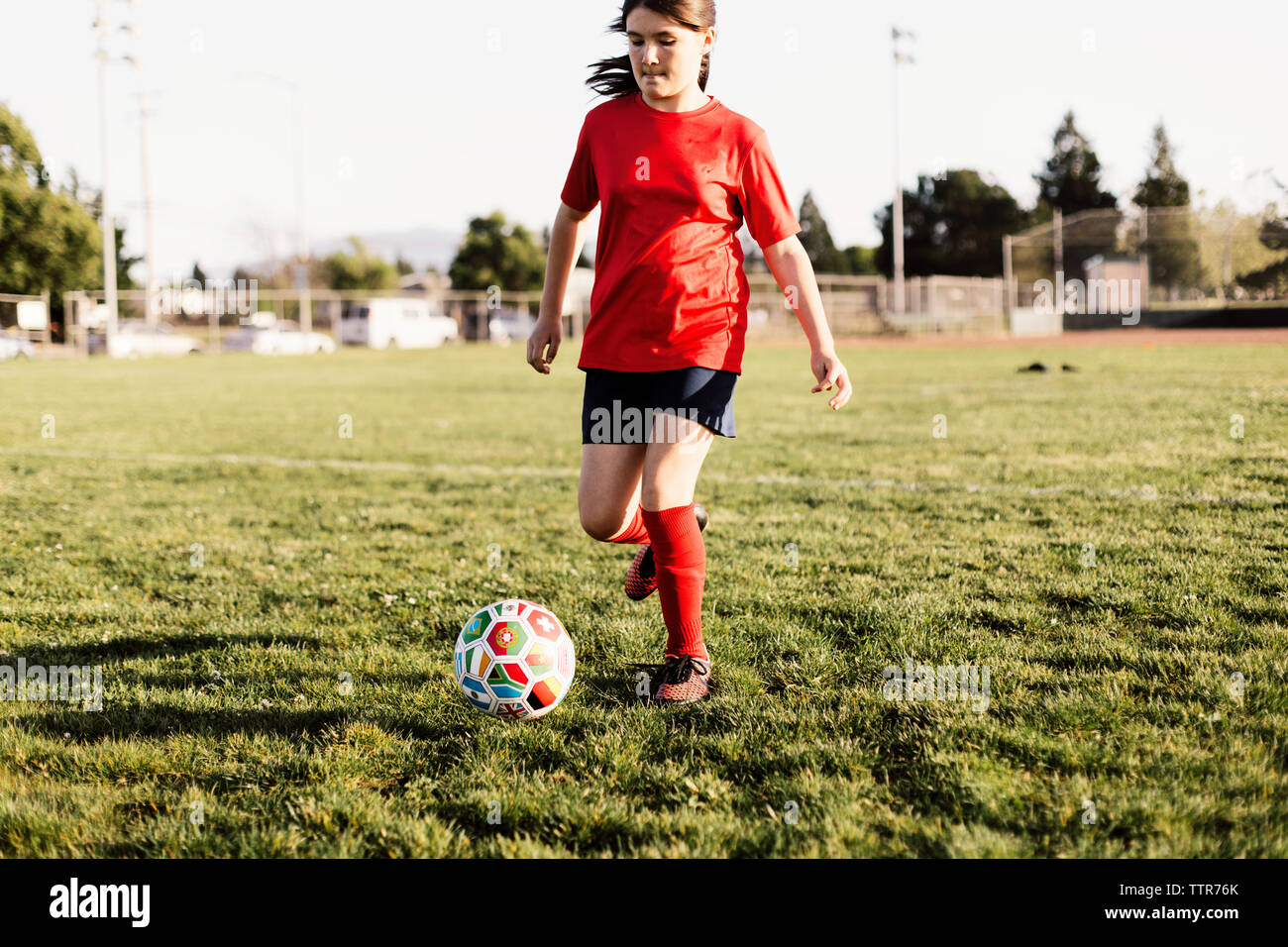 Child kicking ball hi-res stock photography and images - Alamy