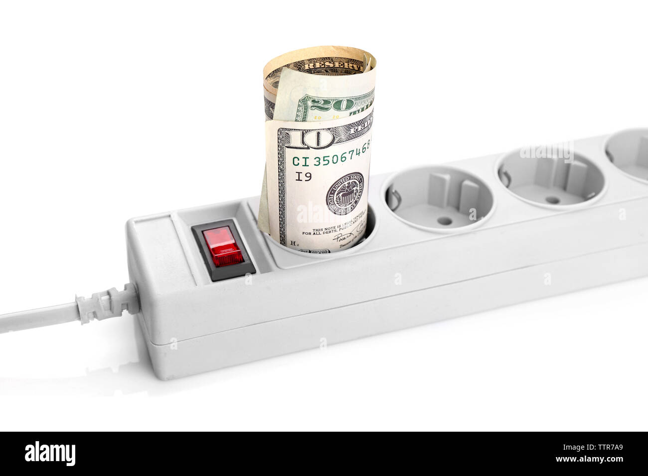 Dollars in power socket on white background Stock Photo - Alamy