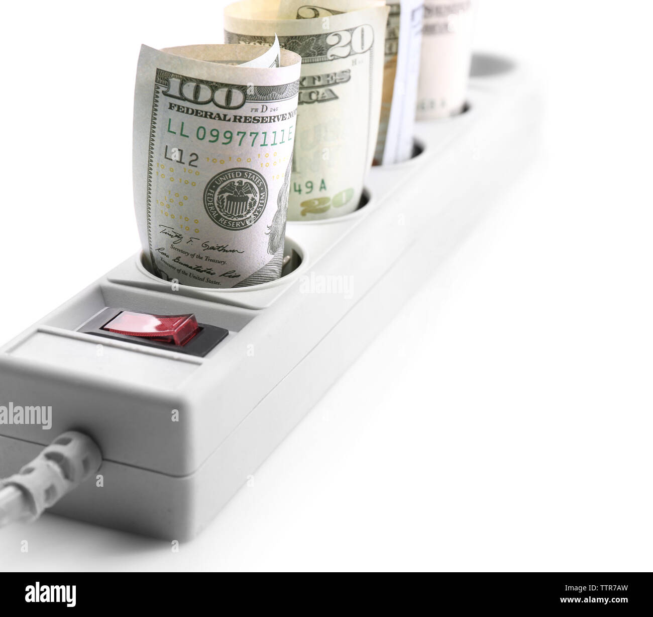 Dollars in power socket on white background Stock Photo - Alamy